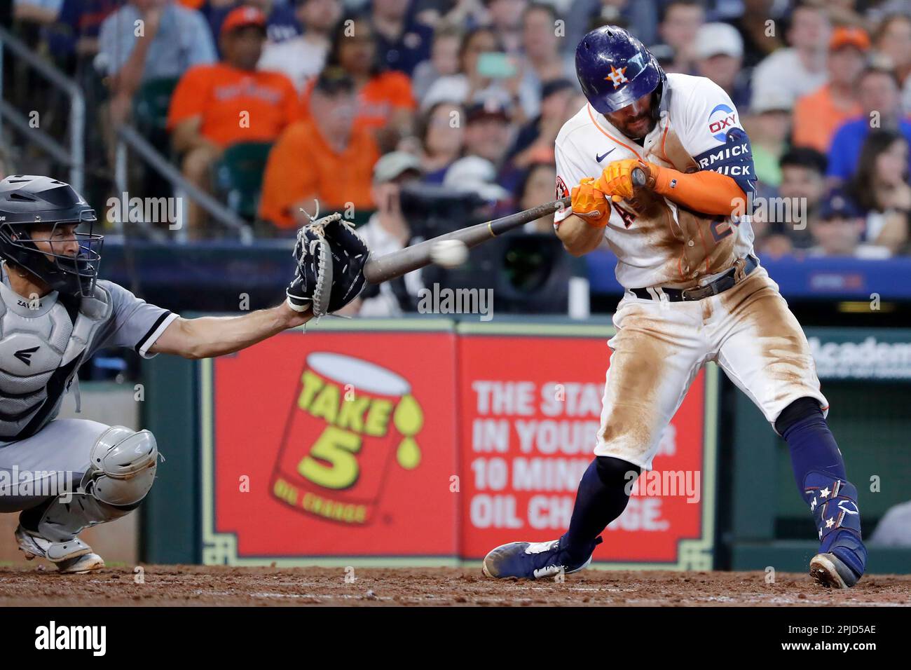Houston Astros' Chas McCormick, right, is hit by a pitch in front of ...