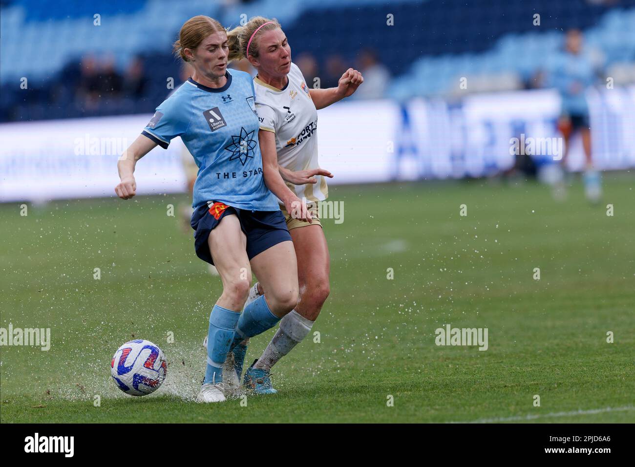 Cannon Clough of Newcastle competes for the ball with Cortnee Vine of ...