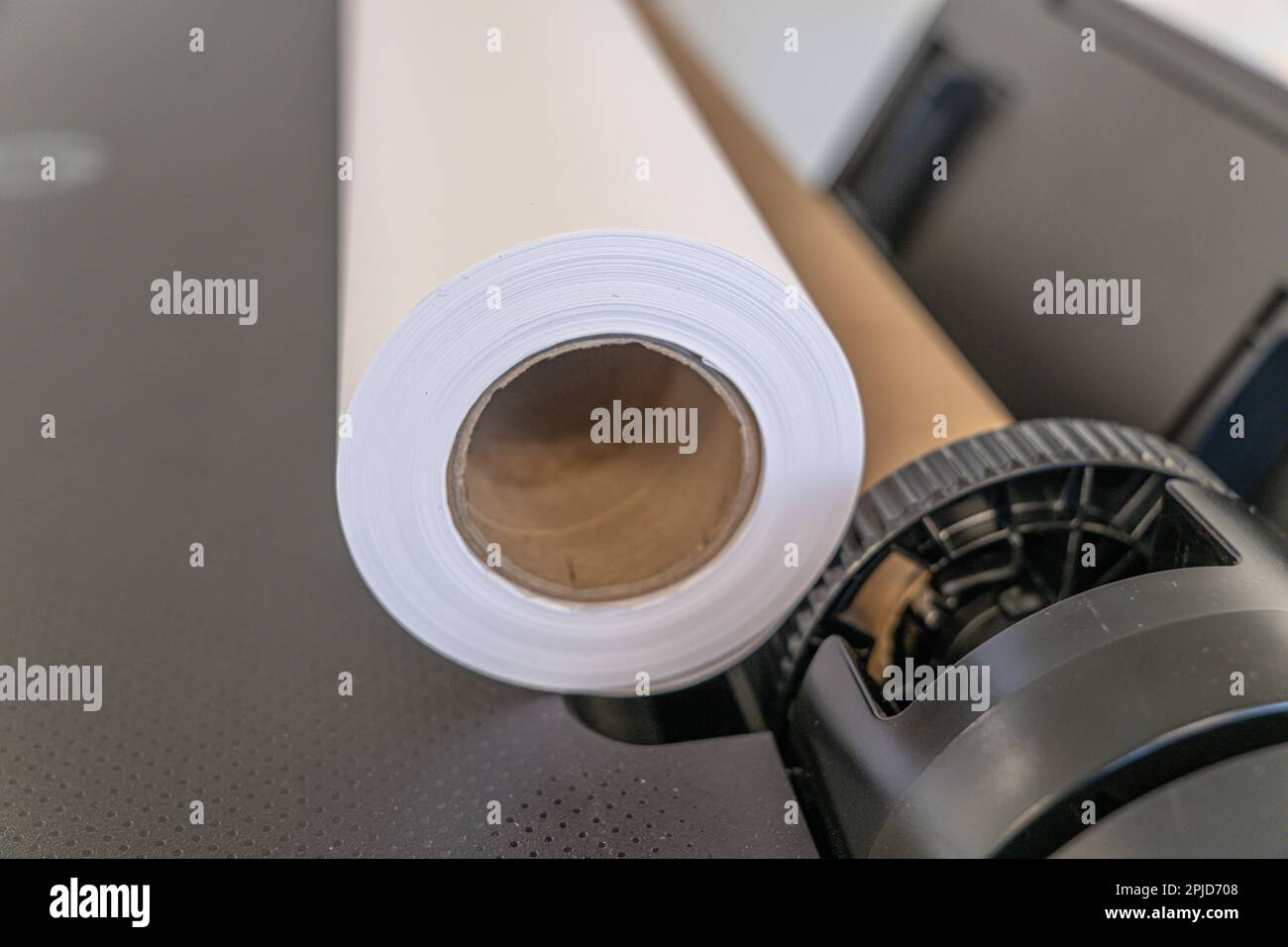 Roll of White printing paper to be loaded on printer Stock Photo - Alamy