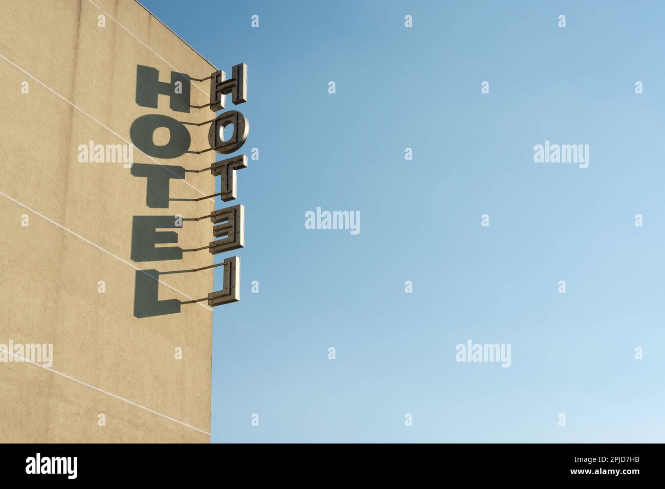 Hotel text casting shadows on building wall, copy space Stock Photo - Alamy
