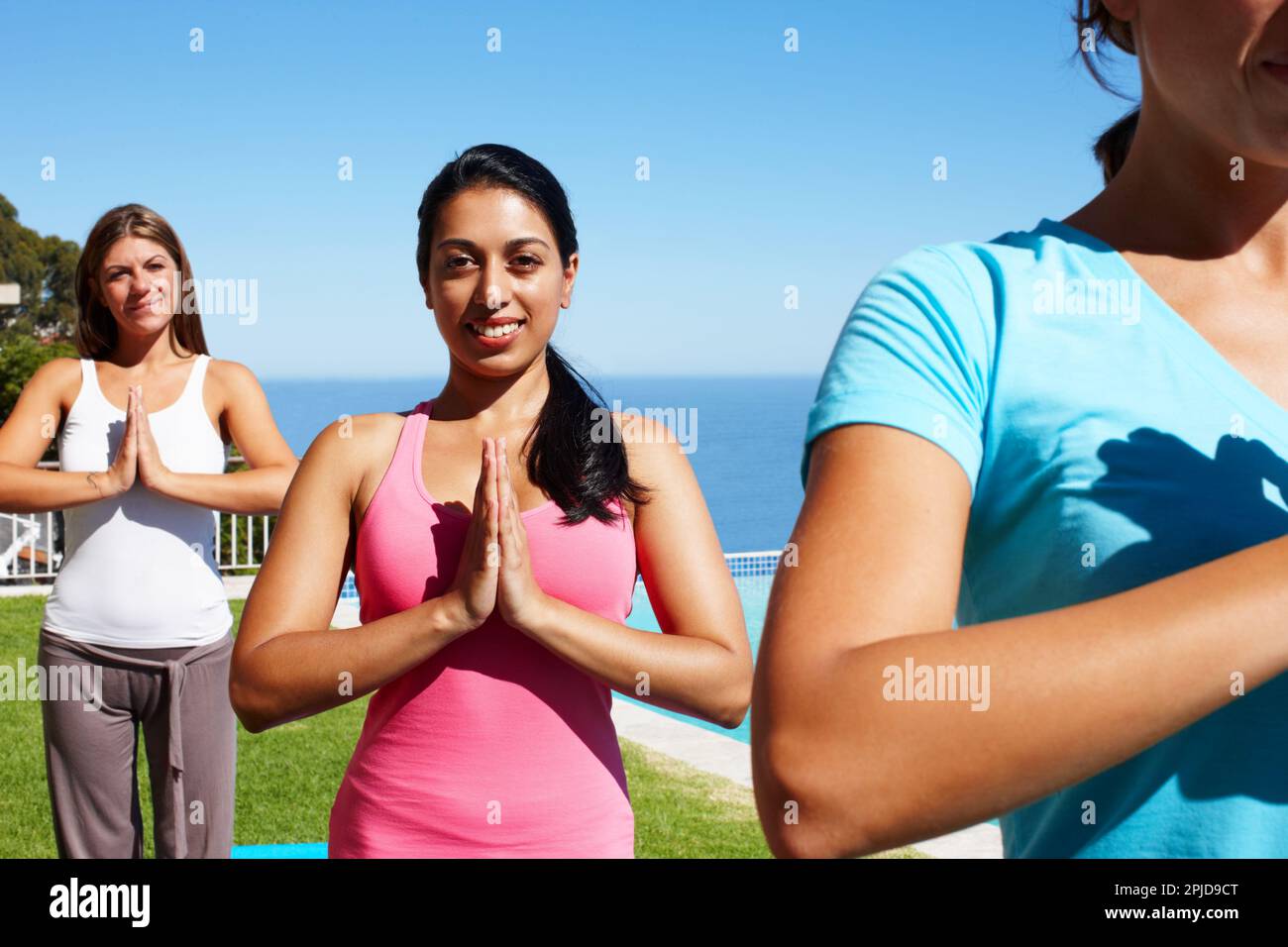 Masters of inner peace. Three young women in a yoga position on the ...