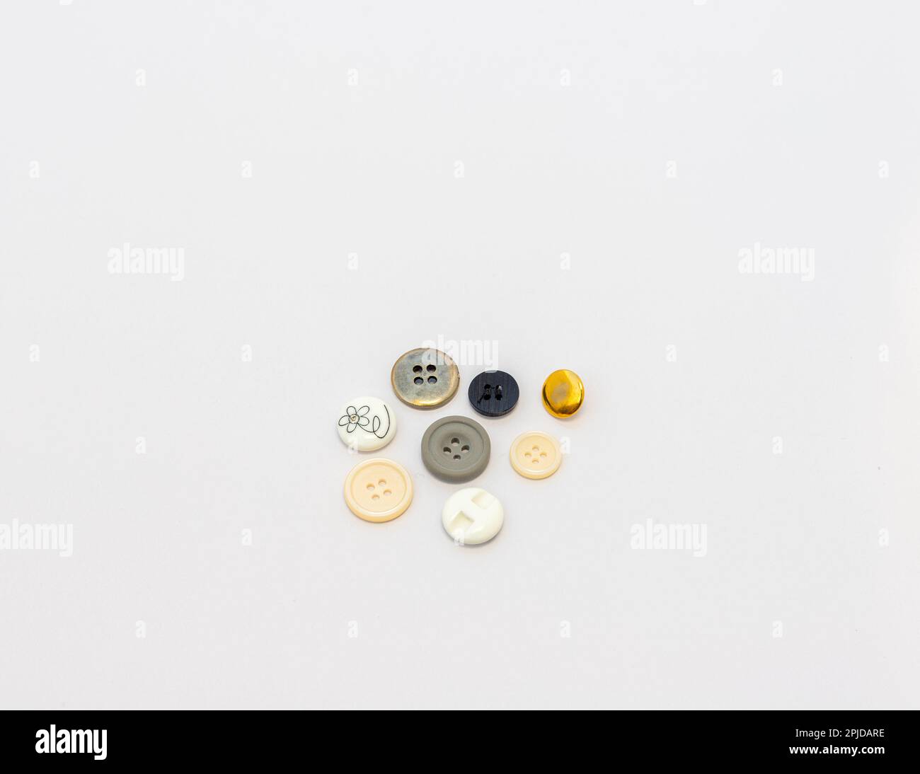 Various sewing button set on isolated white background Stock Photo - Alamy