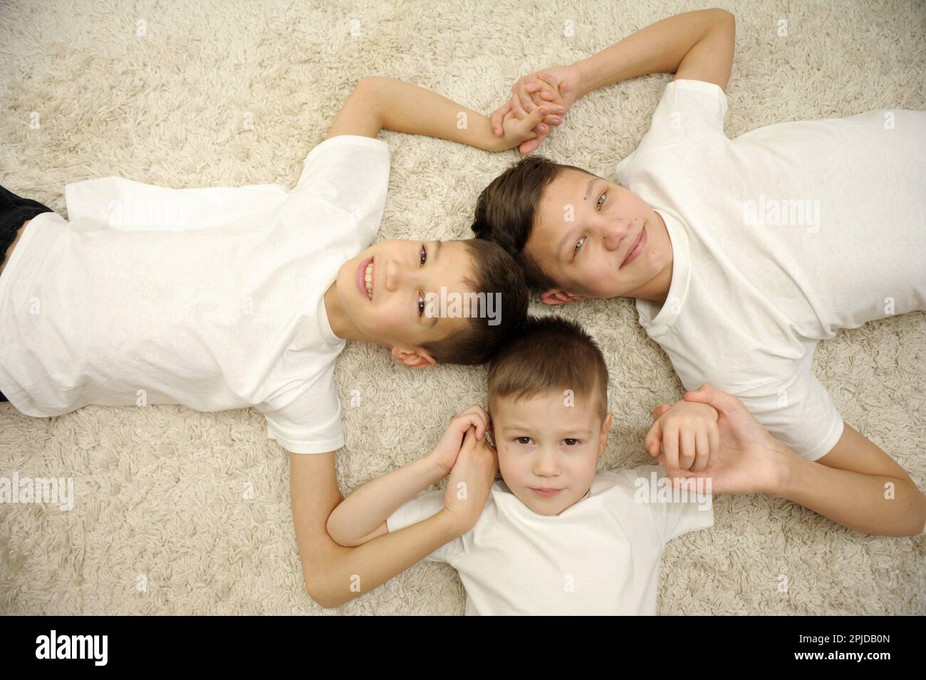 Happy intergenerational 3 three men family concept lying in circle ...