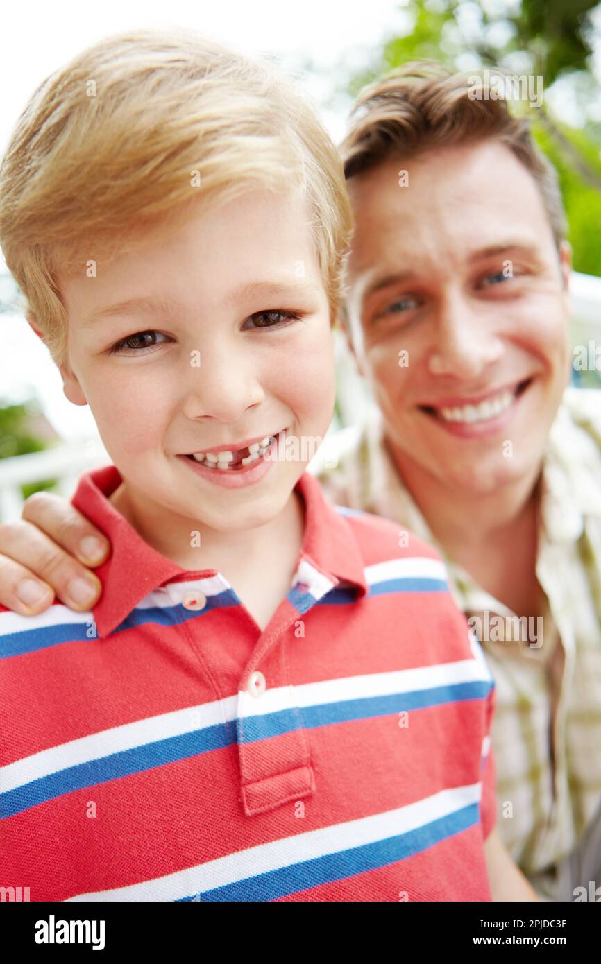 My dad loves me so much. A young boy with a missing tooth spending time with his father Stock ...