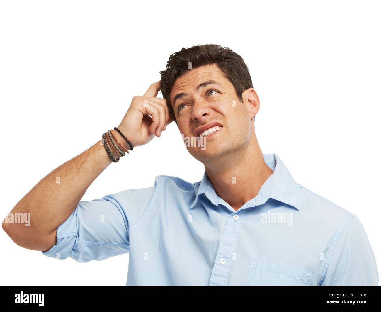 I really cant decide. A handsome young man scratching his head while ...