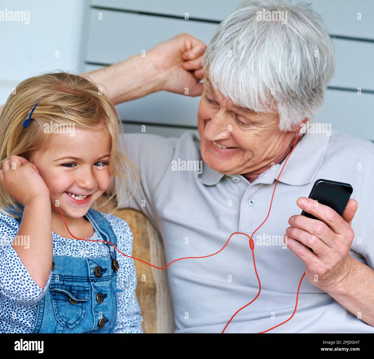 Music transcends generations. an adorable little girl listening to ...