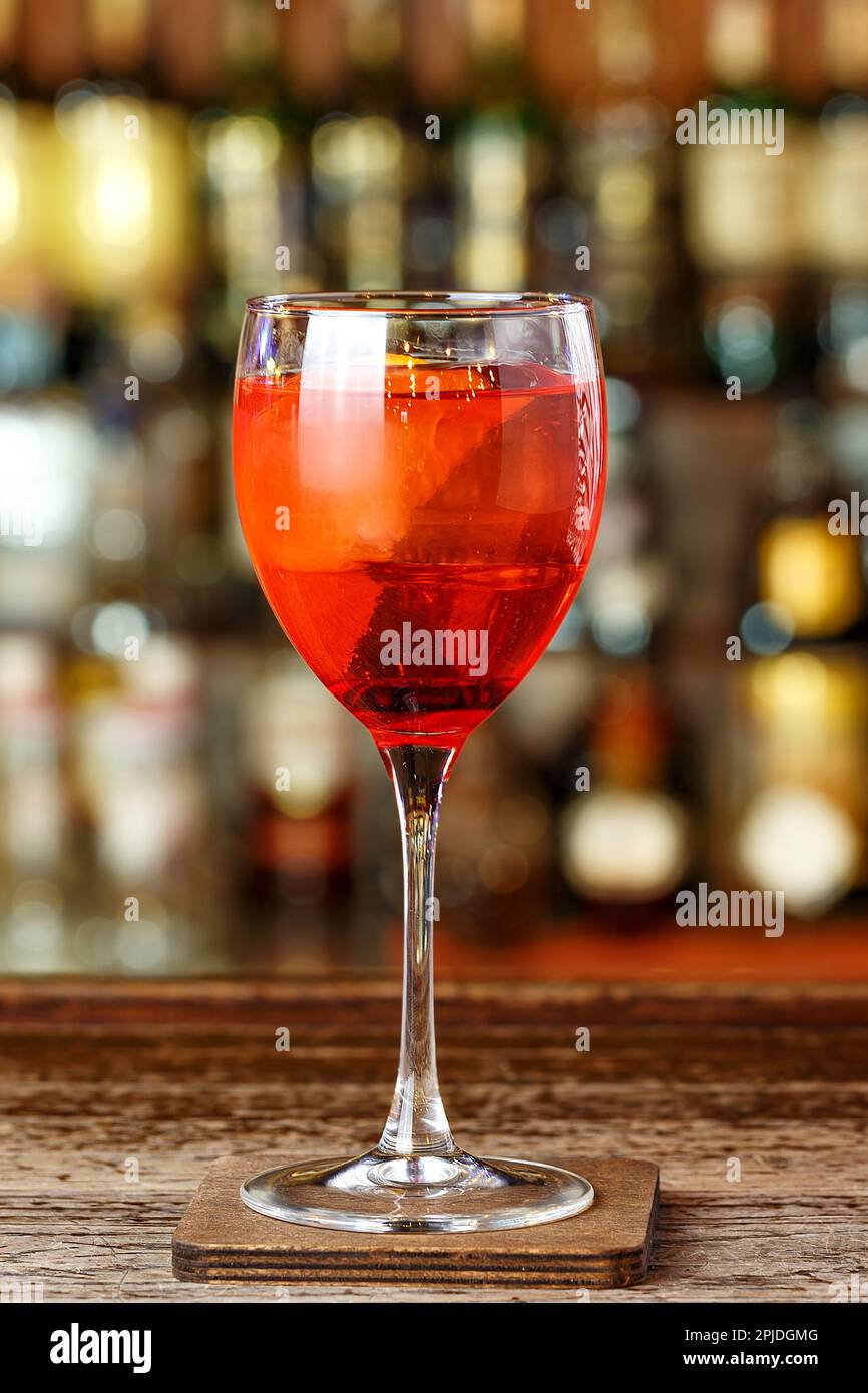 Cocktail aperol spritz with ice on the bar, on a blurry background ...