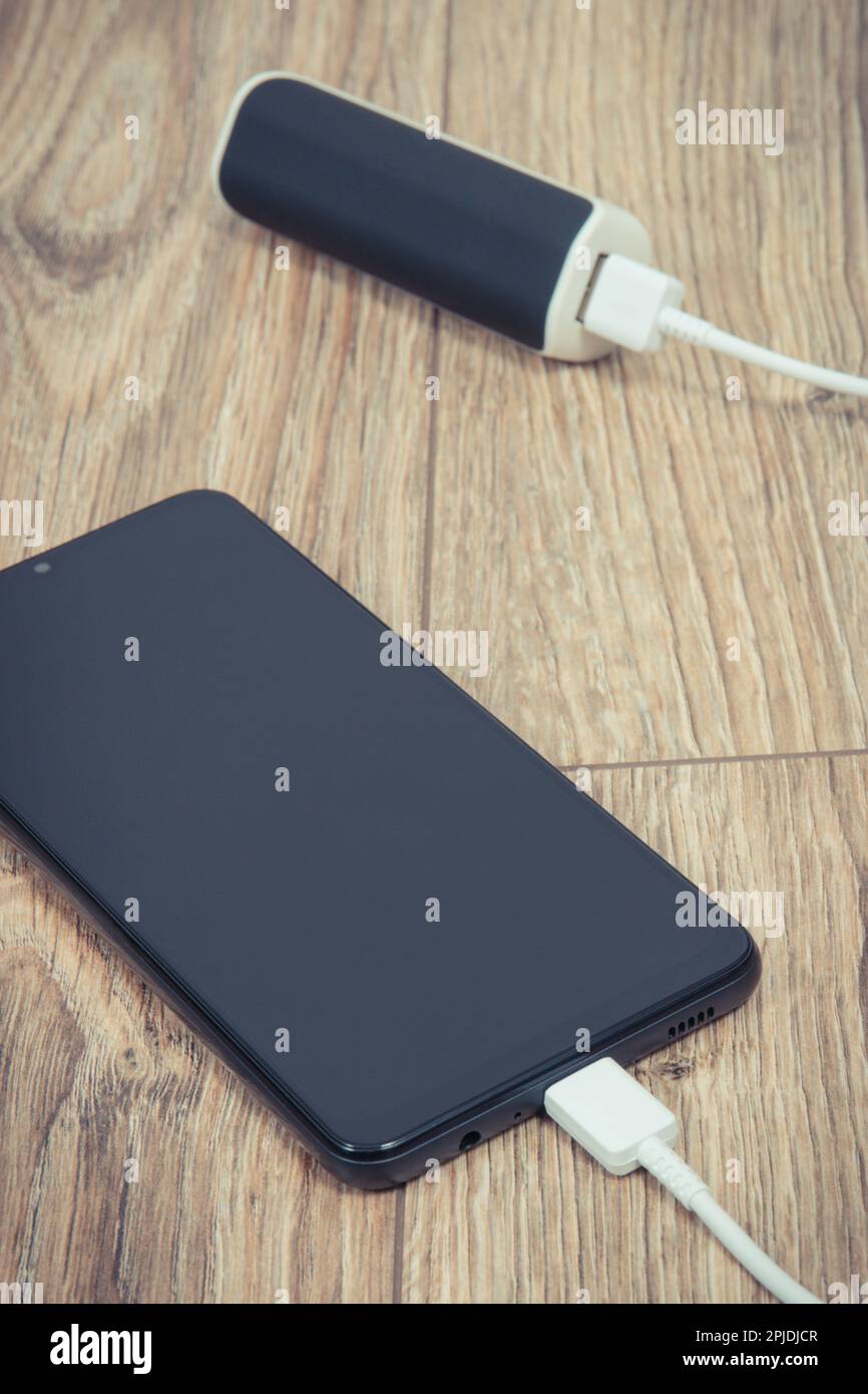 External powerbank charging empty battery of smartphone or mobile phone ...