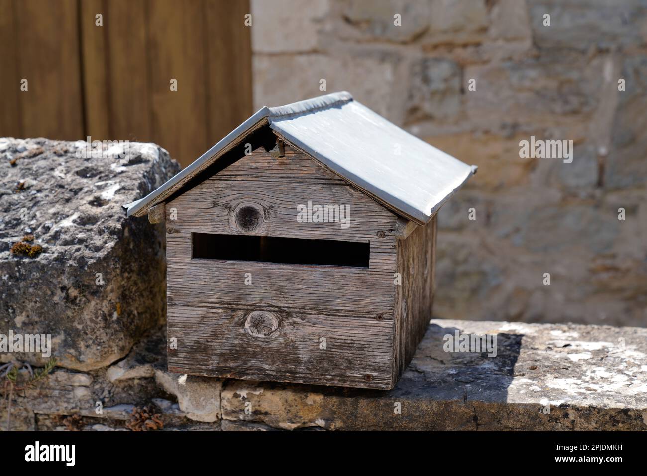 wooden dark grey classic letter box natural on old ancient stone wall ...