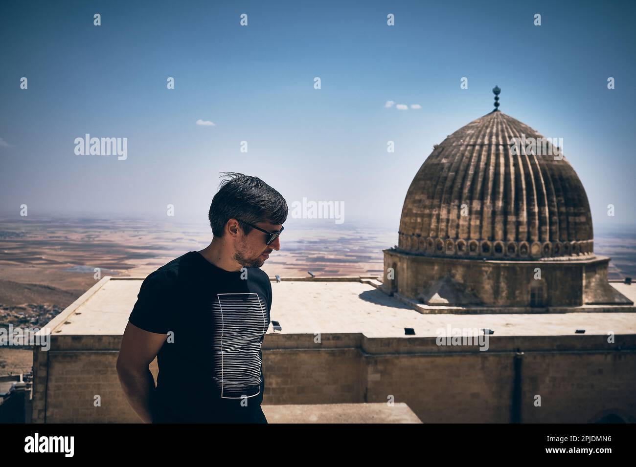 Man on roof opposite mosque dome Stock Photo - Alamy