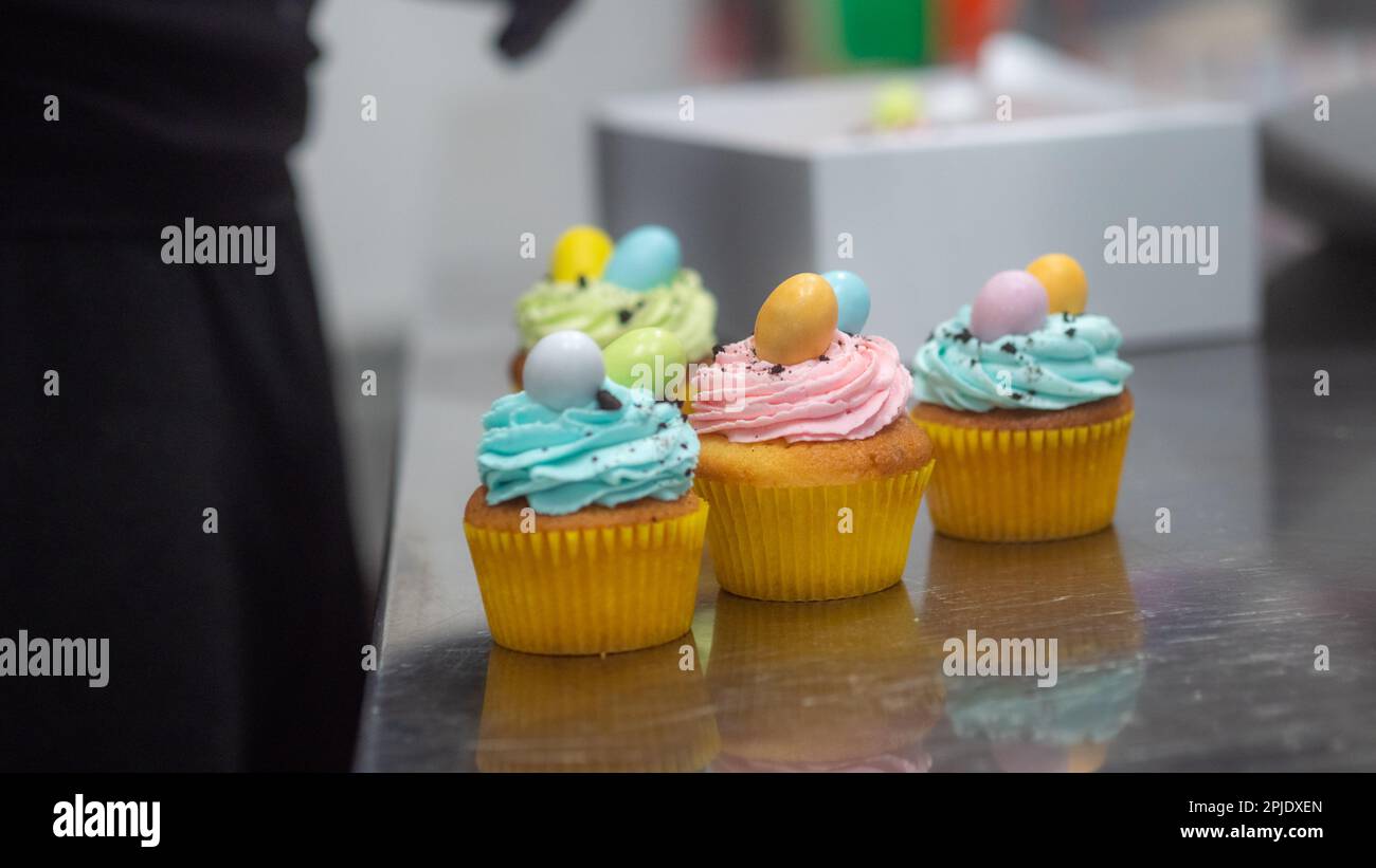easter pastel handmade group of muffins with confetti chocolate eggs on ...