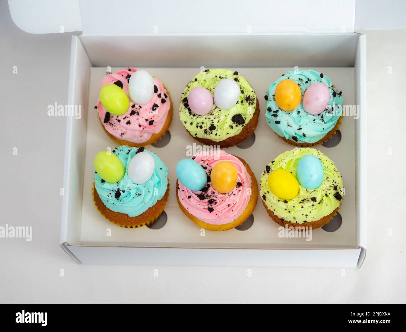 easter pastel handmade group of muffins with confetti chocolate eggs on ...