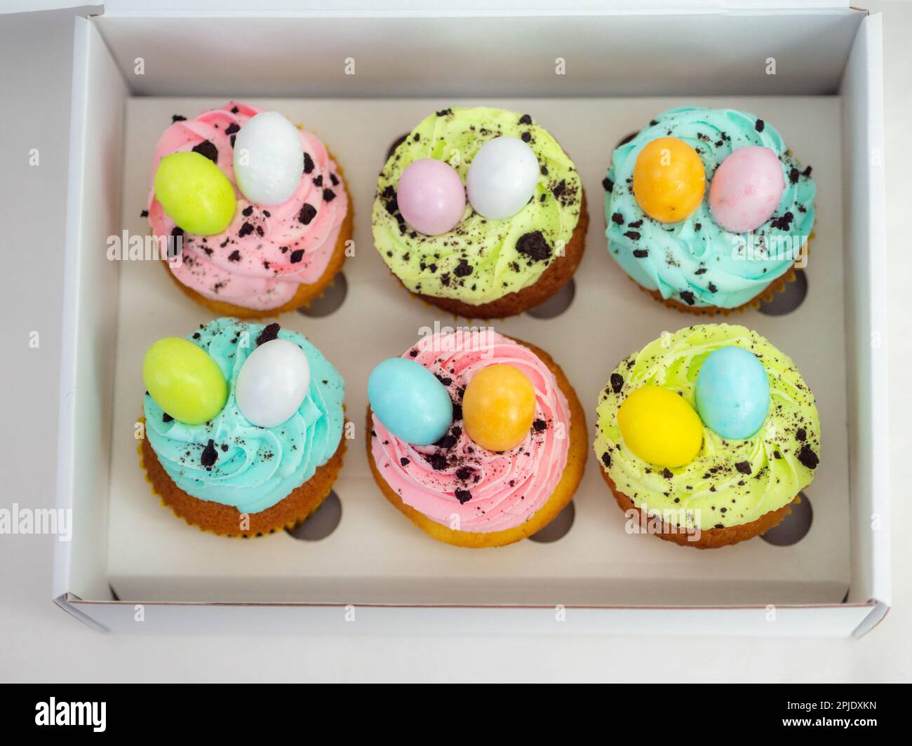 easter pastel handmade group of muffins with confetti chocolate eggs on ...