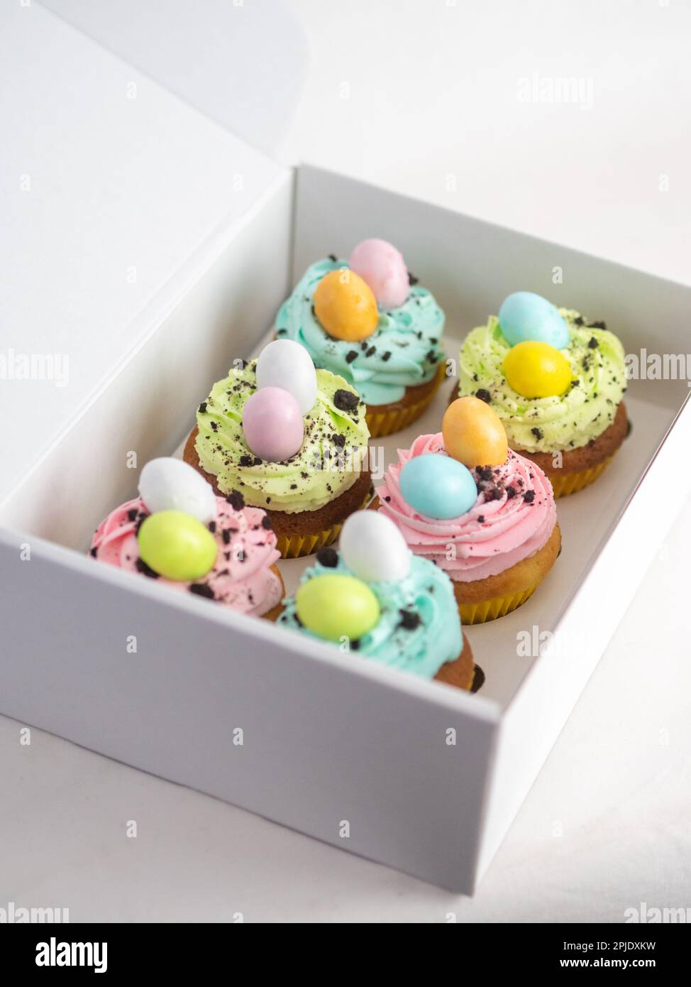 easter pastel handmade group of muffins with confetti chocolate eggs on ...