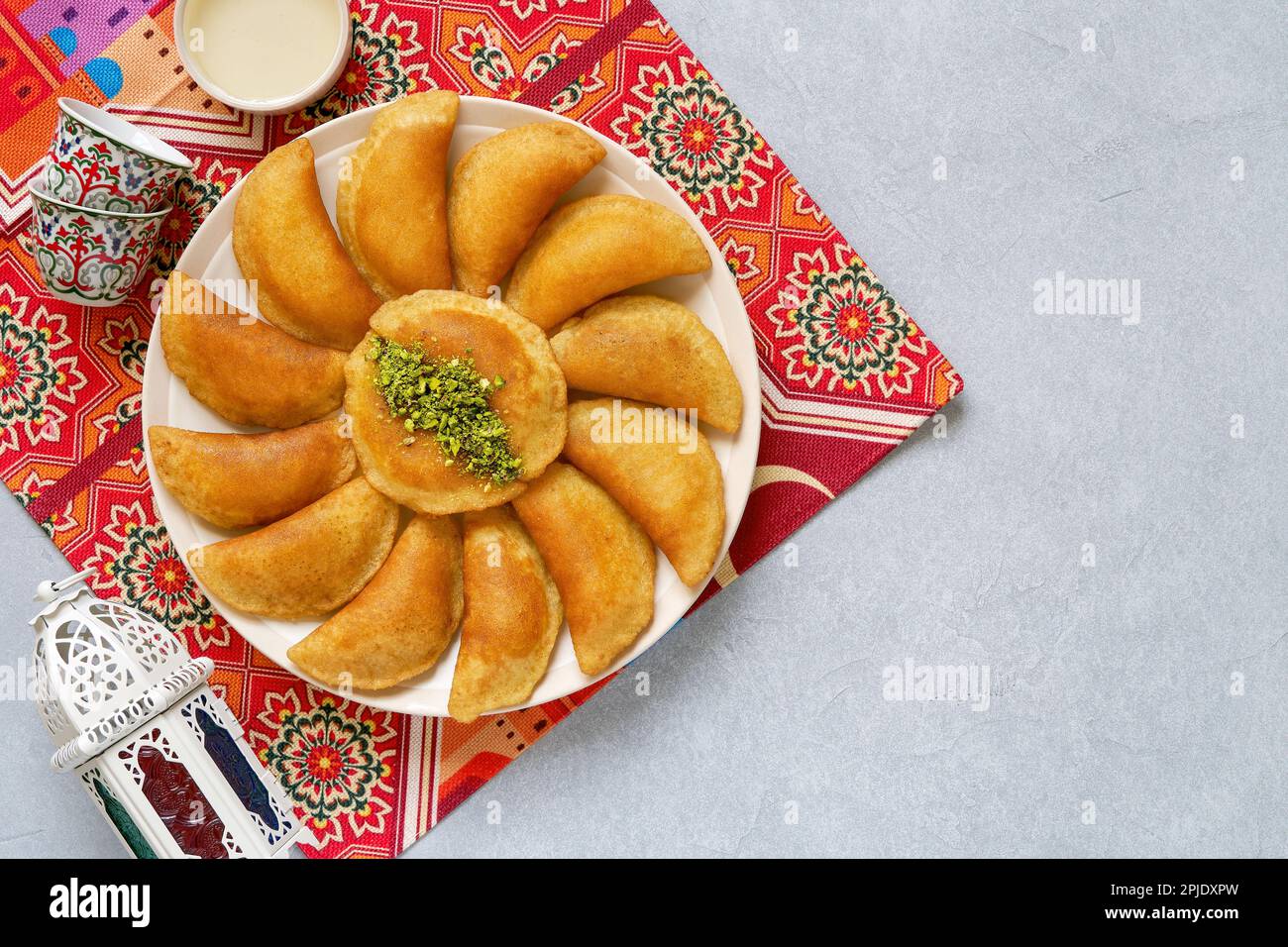 Arabian pancake Qatayef with qishta cream and pistachio . Traditional ...