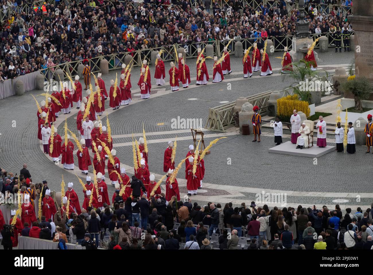 Pope Francis watch the procession of cardinals as he prepares to ...