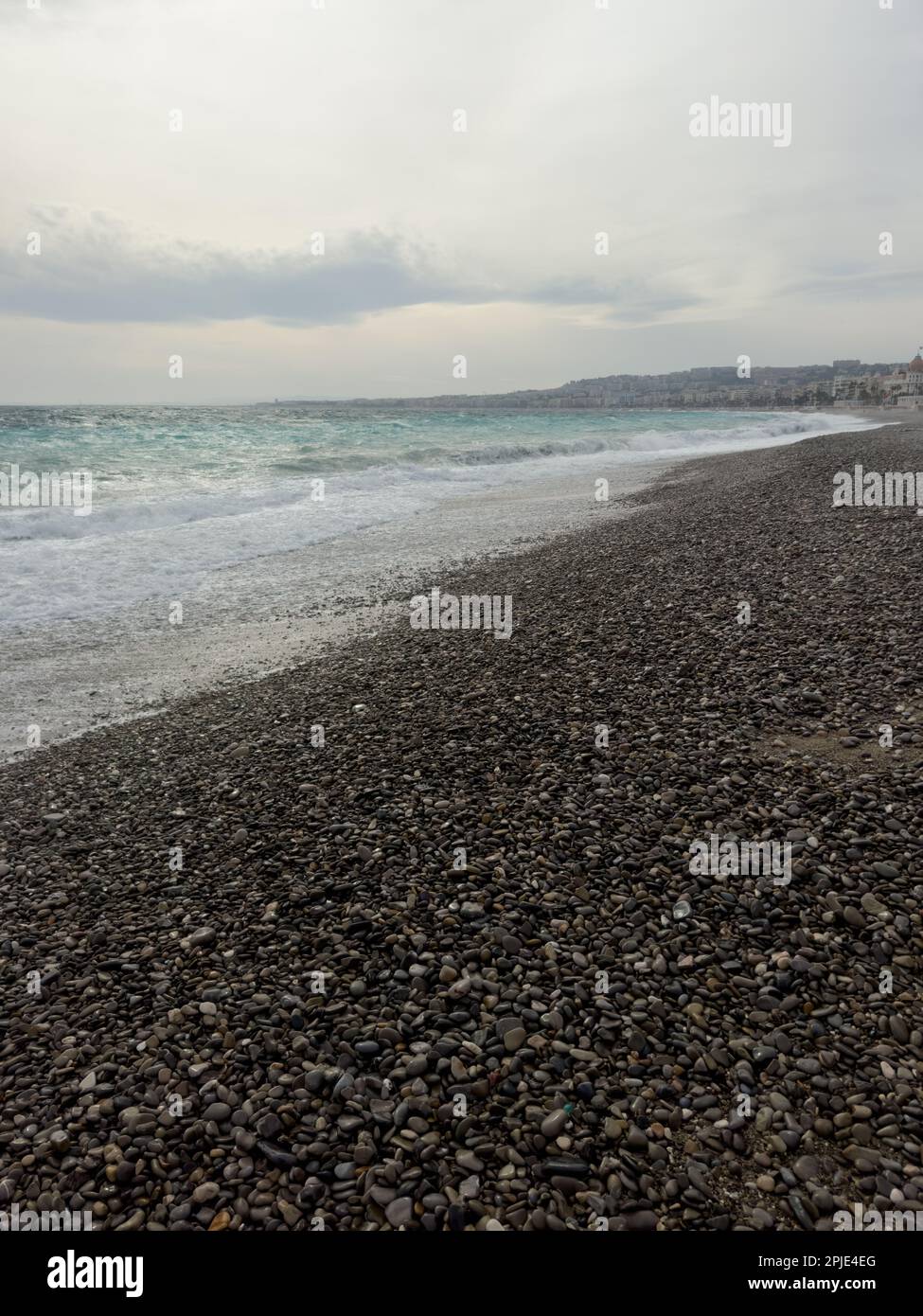 Nice, France - circa March 2023: Pebble beach of Nice, France with ...