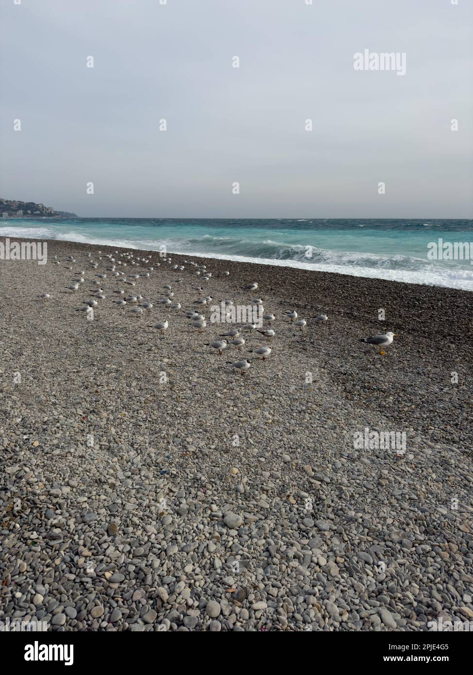 Pebble beach of Nice, France with azure waves of mediterranean sea ...