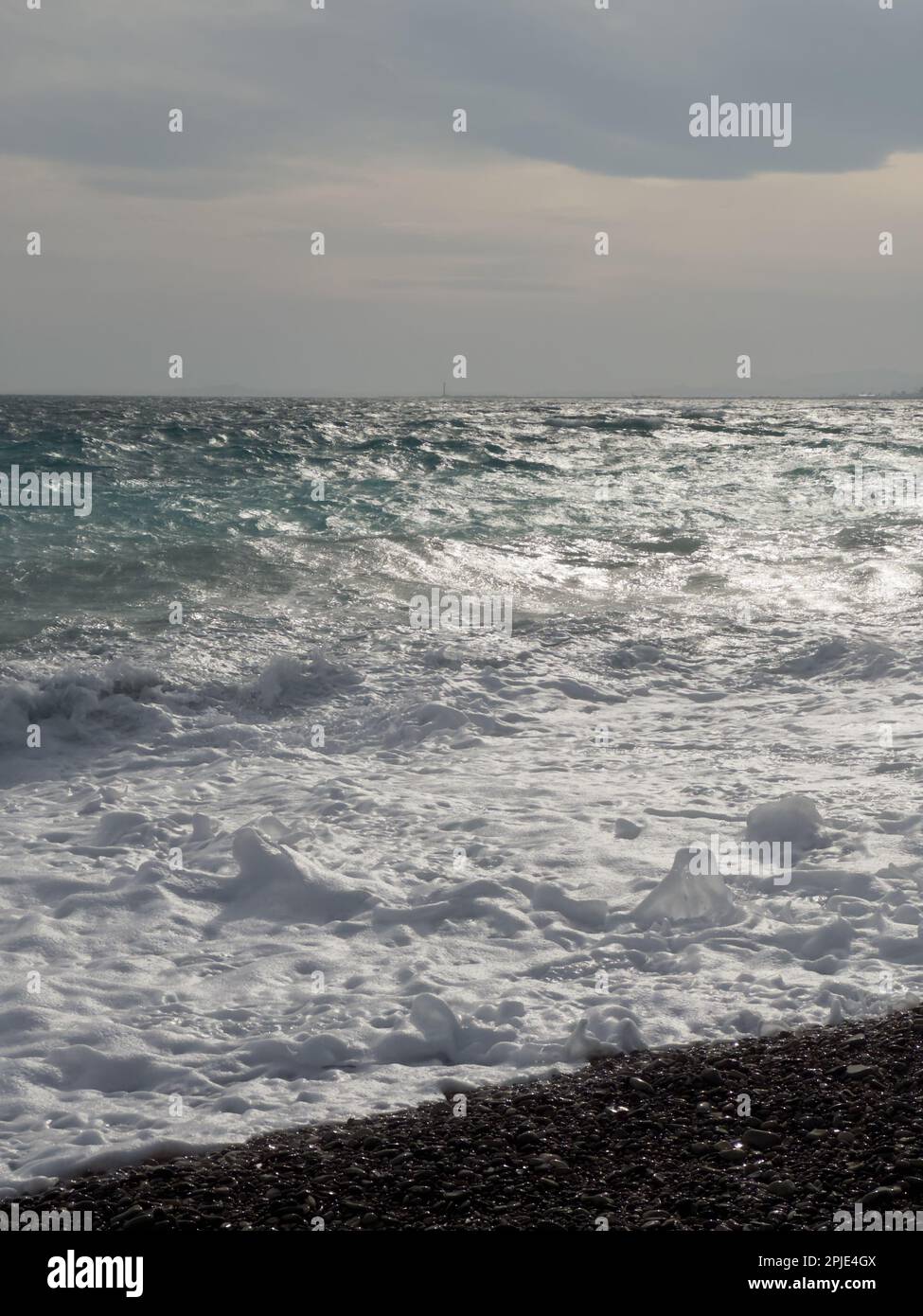 Pebble beach of Nice, France with azure waves of mediterranean sea ...