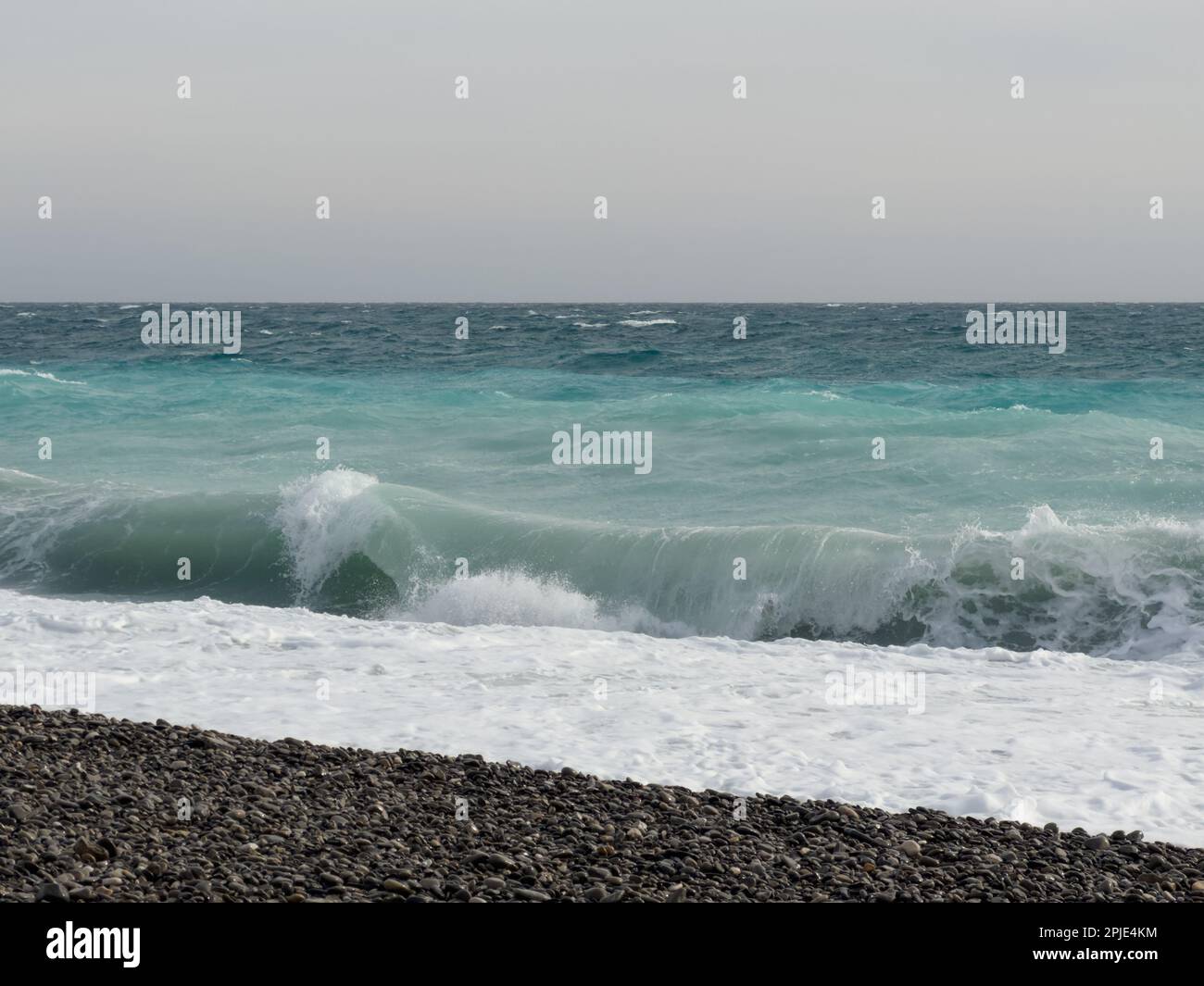 Pebble beach of Nice, France with azure waves of mediterranean sea ...