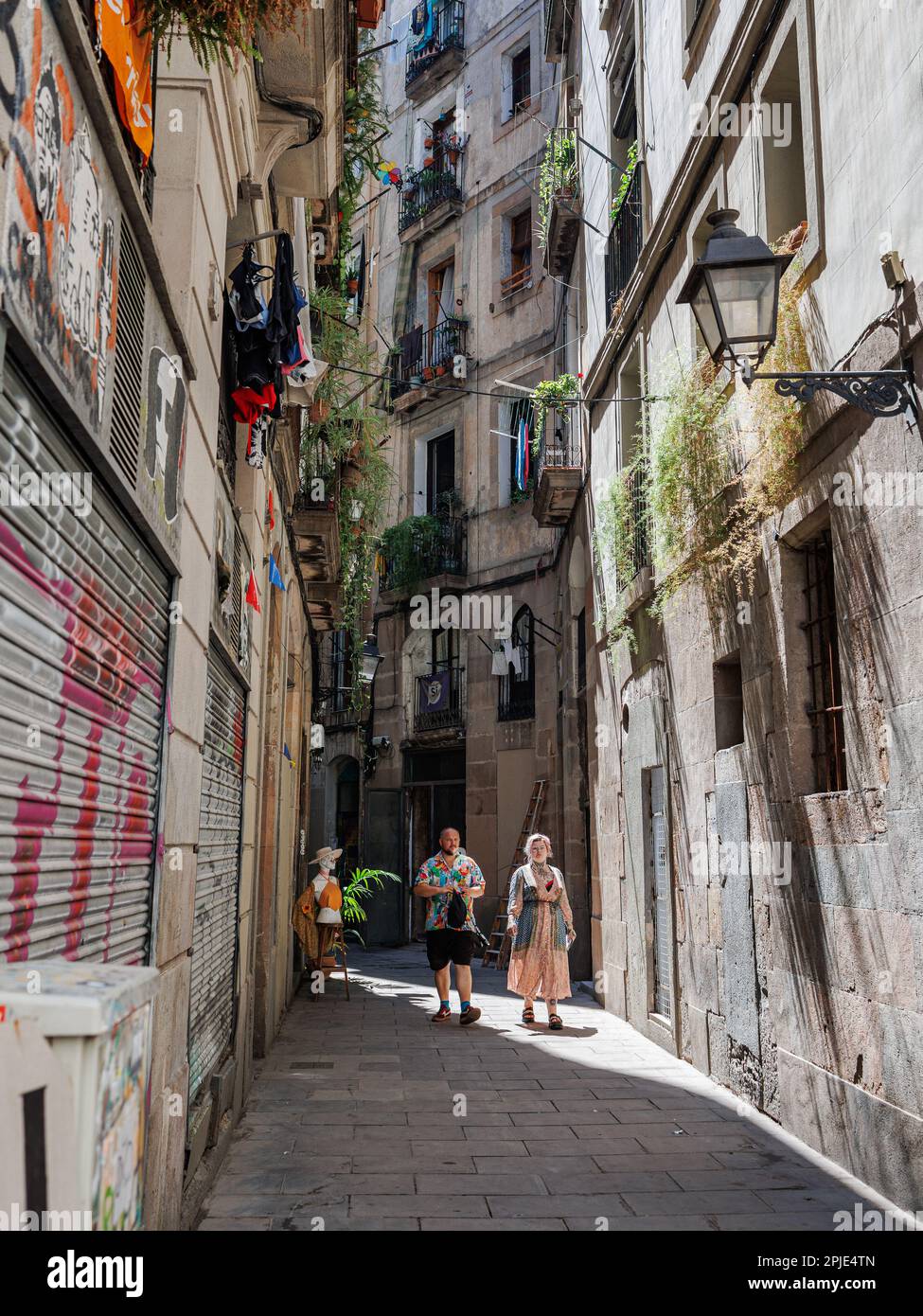 Couple Walking in a Narrow Barcelona Street with Antique Lamppost in ...