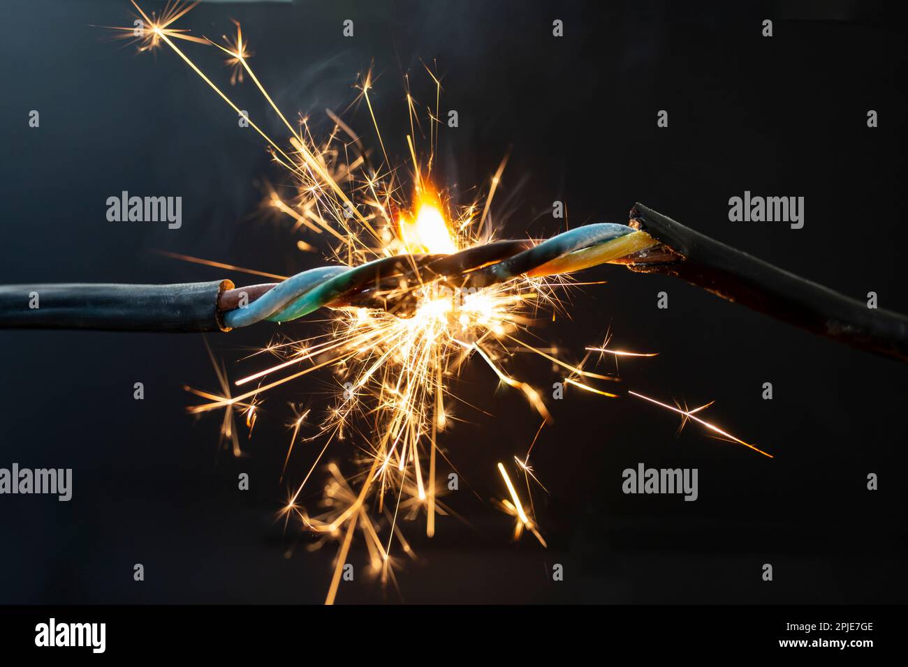 flame smoke and sparks on an electrical cable, fire hazard concept ...