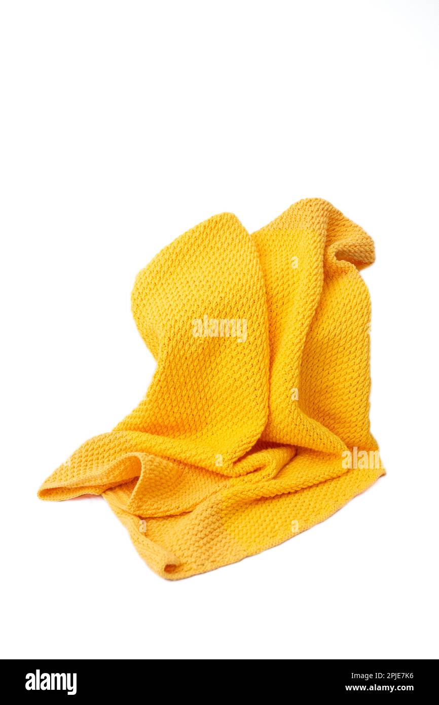Yellow crochet blanket folds arranged on white background Stock Photo ...