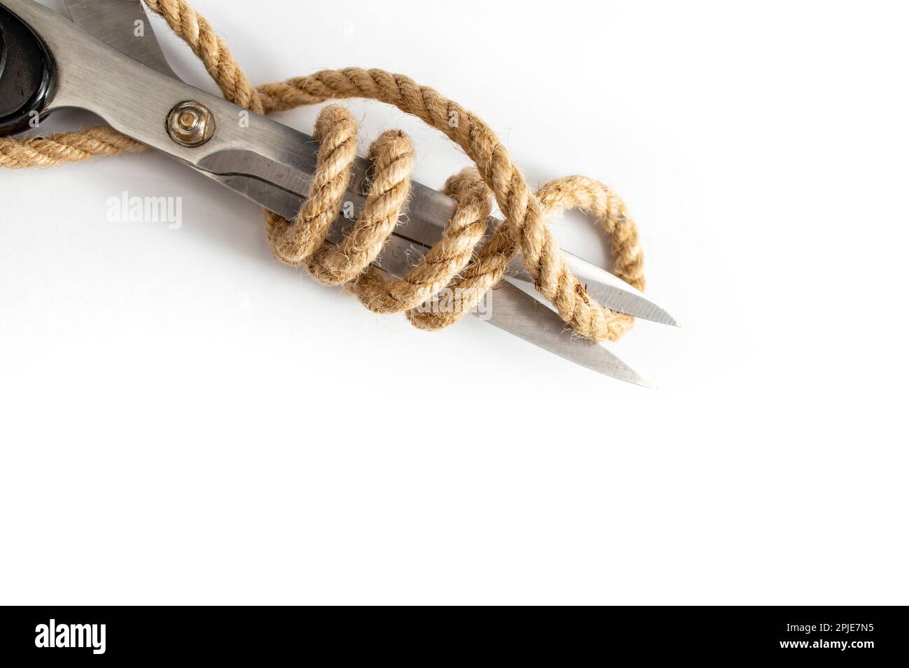 Jute rope wrapped around scissors blades, isolated on white background ...