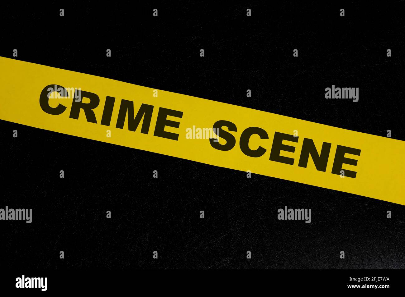 Crime scene yellow barricade tape warning and caution sign in dark ...