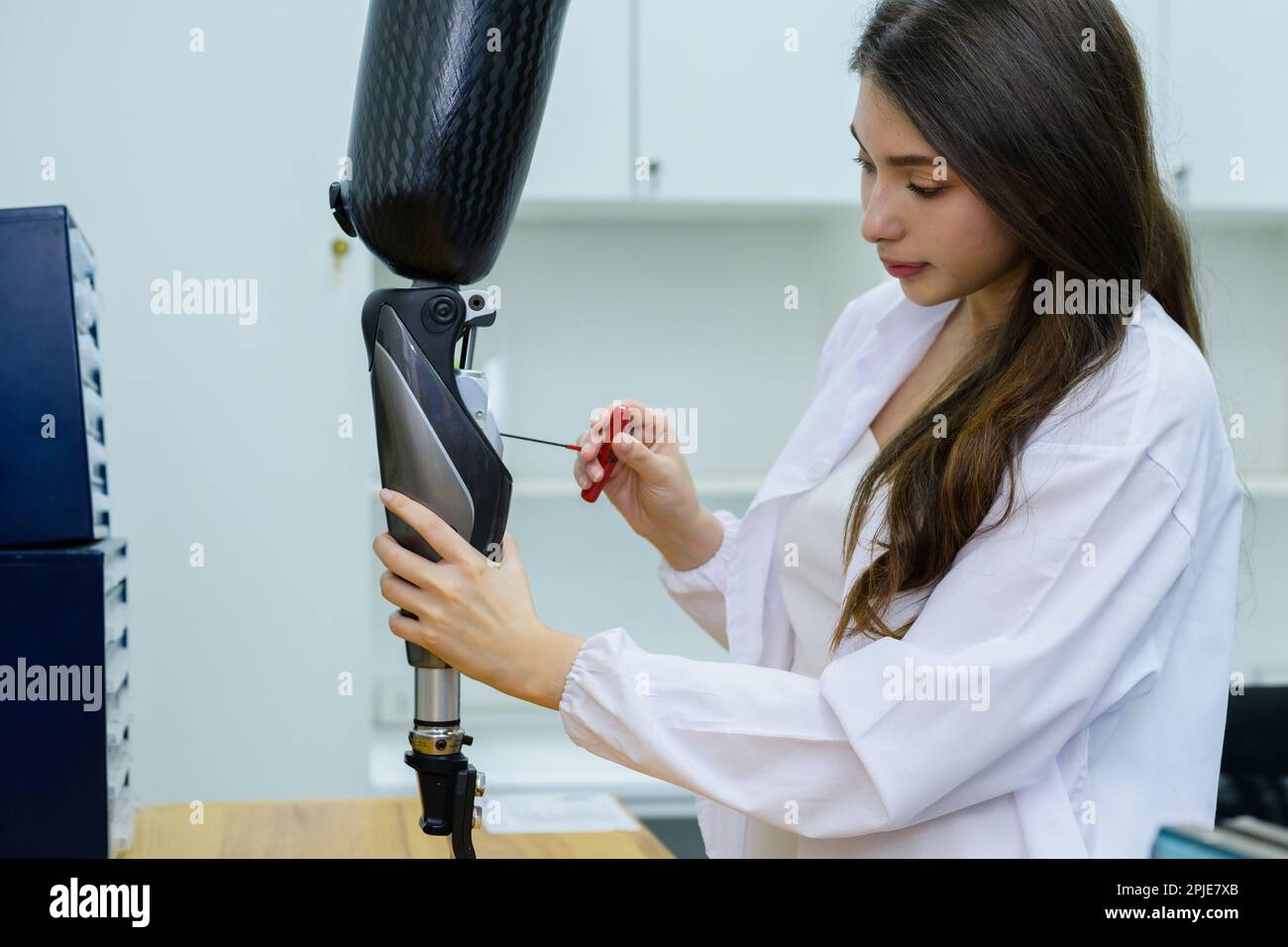 Prosthetic technician holding prosthetic leg checking and controlling ...