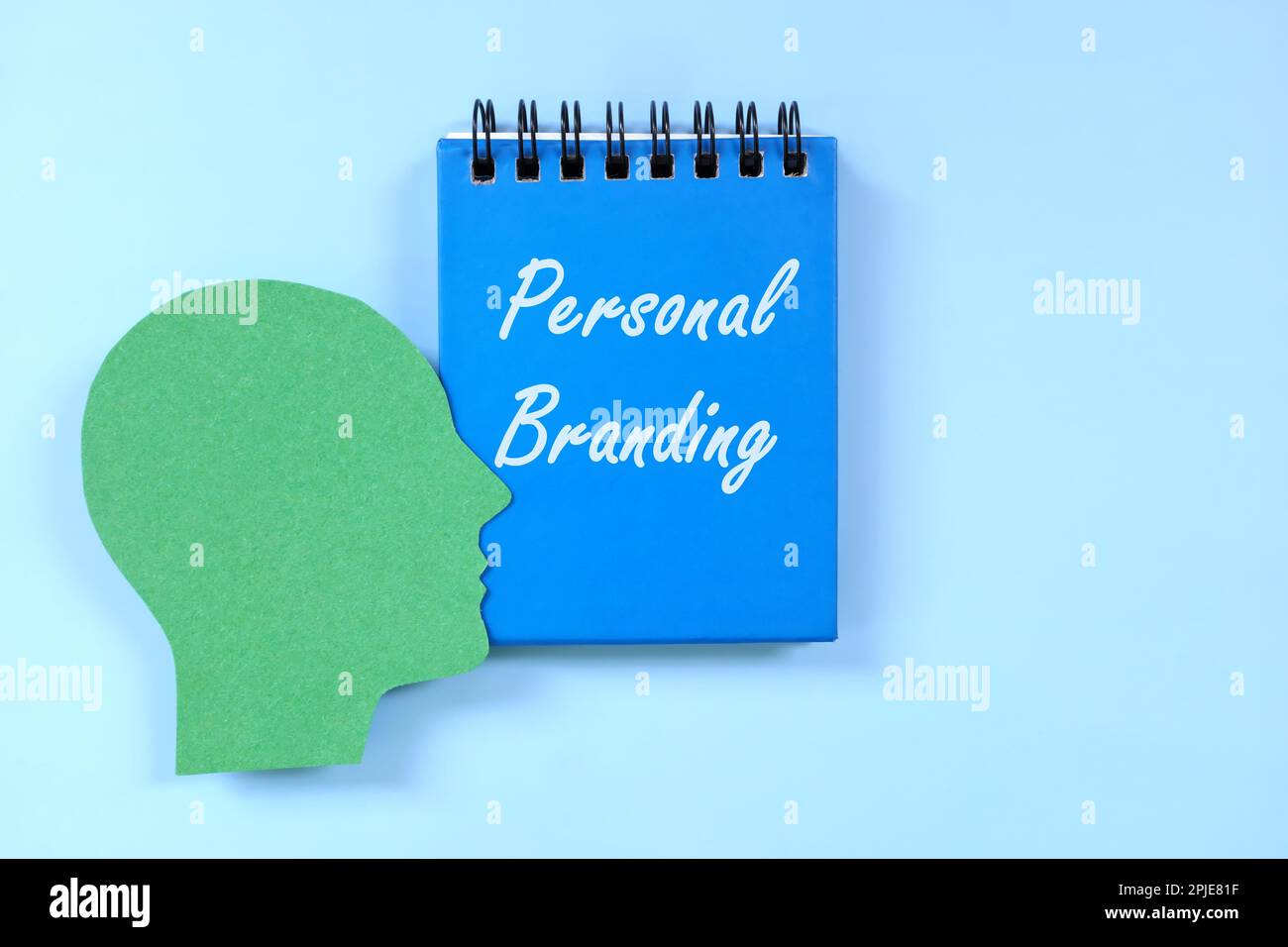 Personal branding concept. Human head profile beside blue notepad with ...