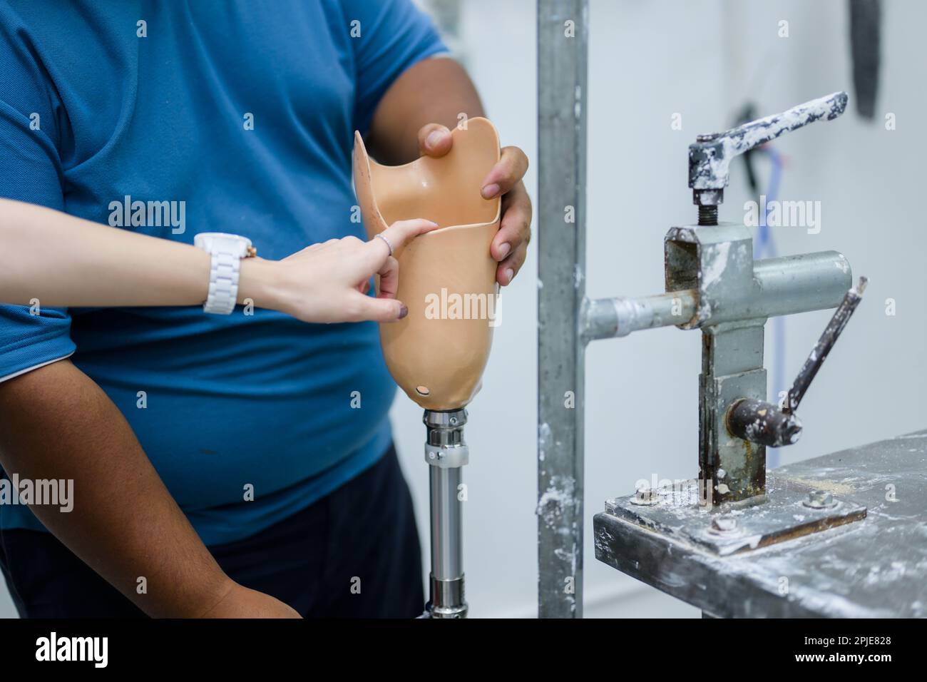 Prosthetic technician holding prosthetic leg checking and controlling ...