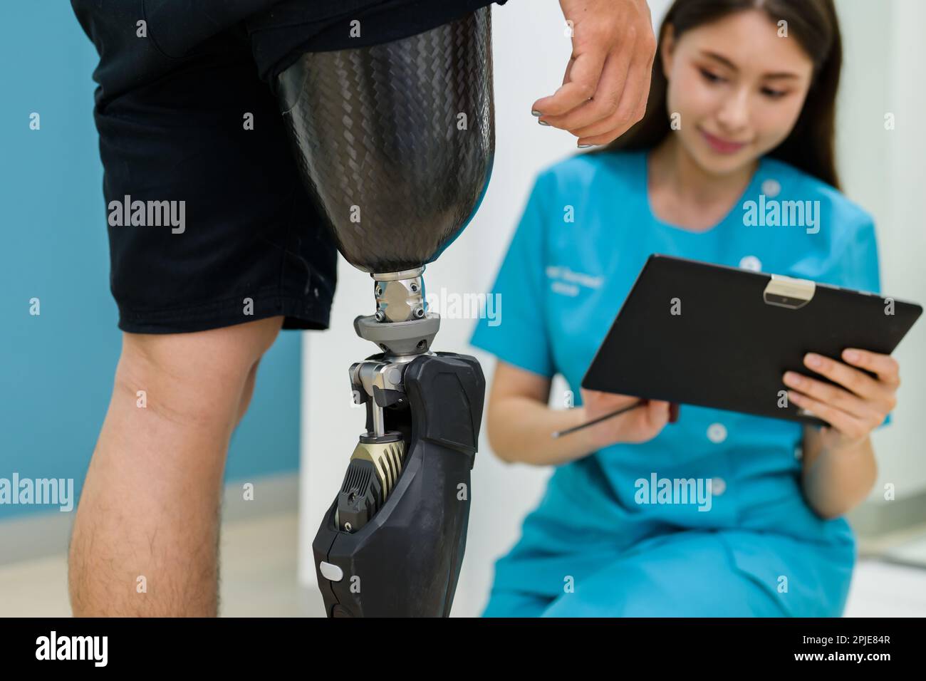 Prosthetist nurse checking prosthetic leg of patient at health care ...