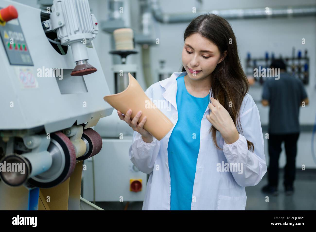 Technician making prosthetic limb using grinder to smooth socket Stock ...