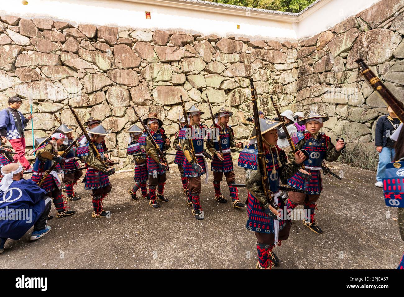 Double line of Japanese children, dressed as Teppou ashjigaru armour ...