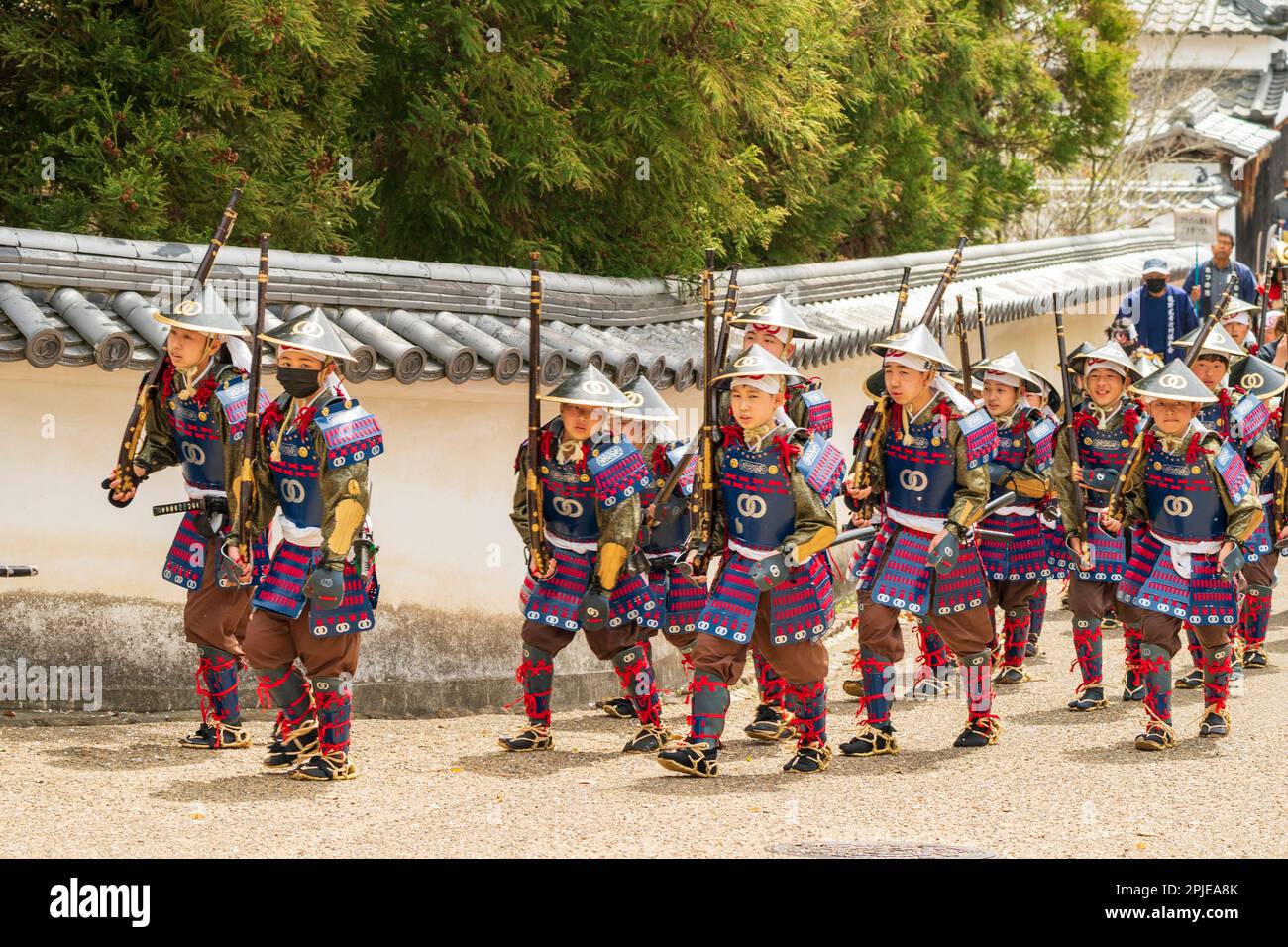 Double line of Japanese children, dressed as Teppou ashigaru armour ...