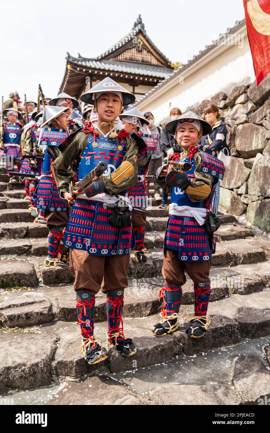 Front of a double line of Japanese children, dressed as Teppou ashigaru ...