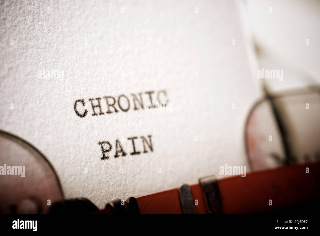 Chronic pain text written with a typewriter Stock Photo - Alamy
