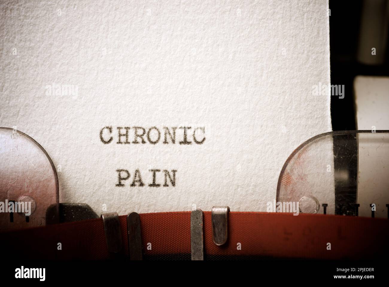 Chronic pain text written with a typewriter Stock Photo - Alamy