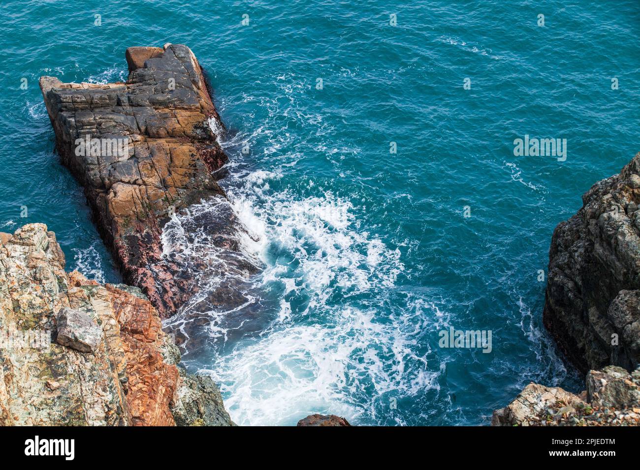 Coastal rocks and shore water, aerial view. Dongbaek Park of Busan city ...