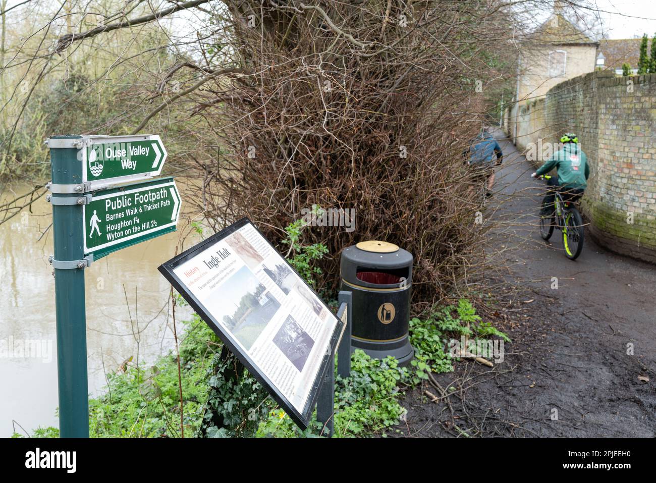 Shallow focus of public footpath signs adjacent to a near flooded river ...