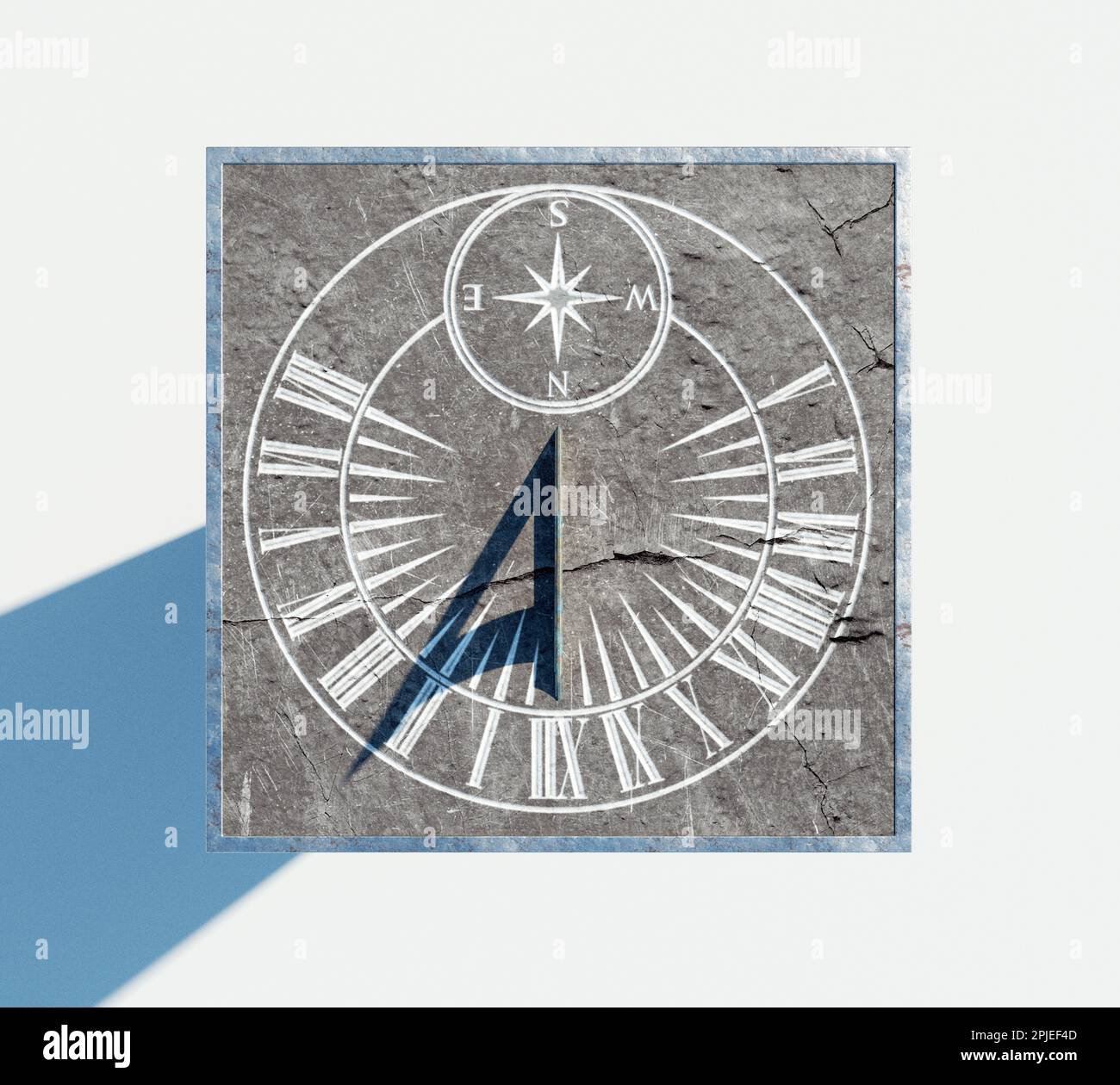 A square stone sundial with etched roman numerals standing an a ...