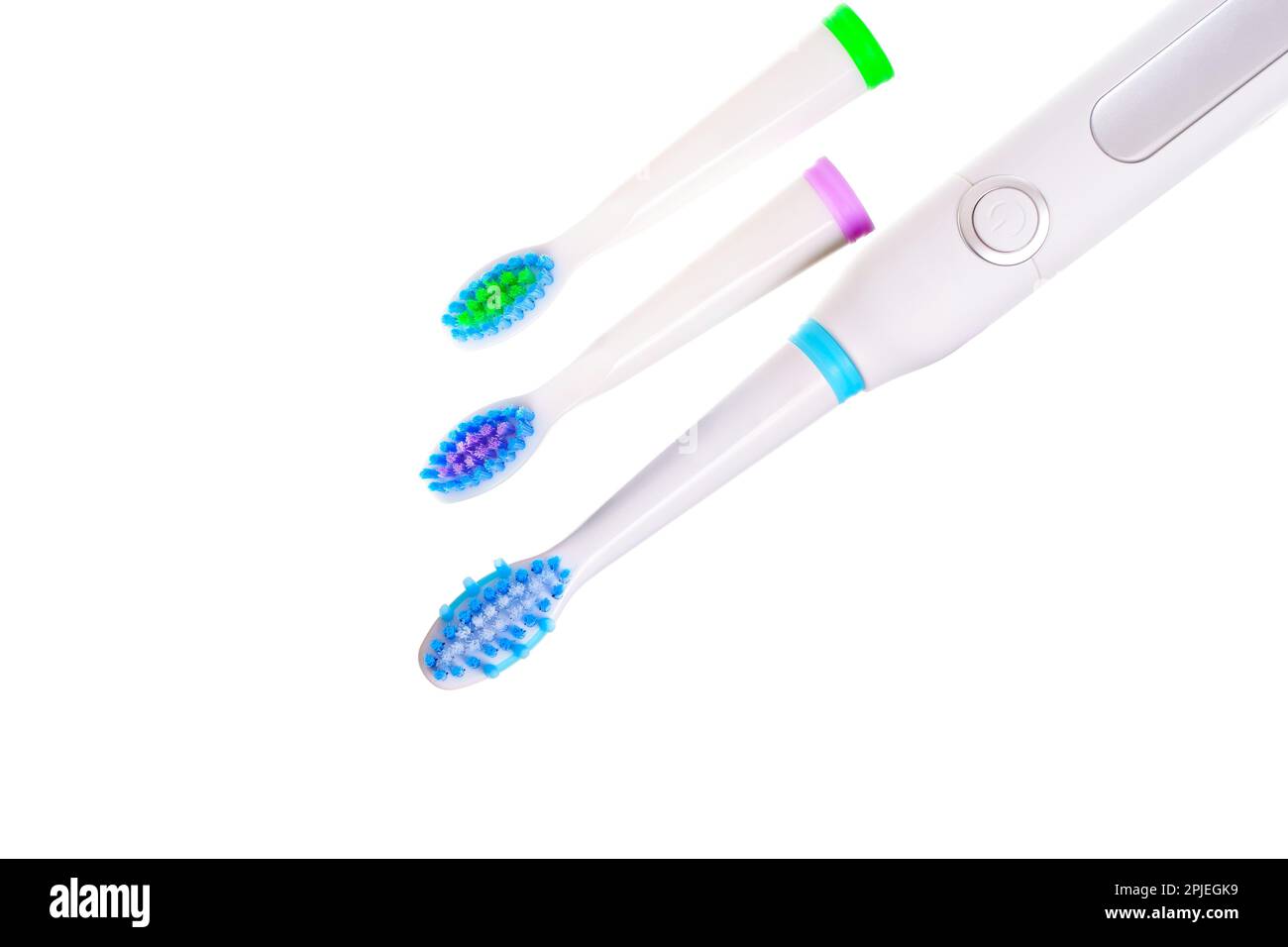 Close-up view of a white electric toothbrush with three brush heads ...