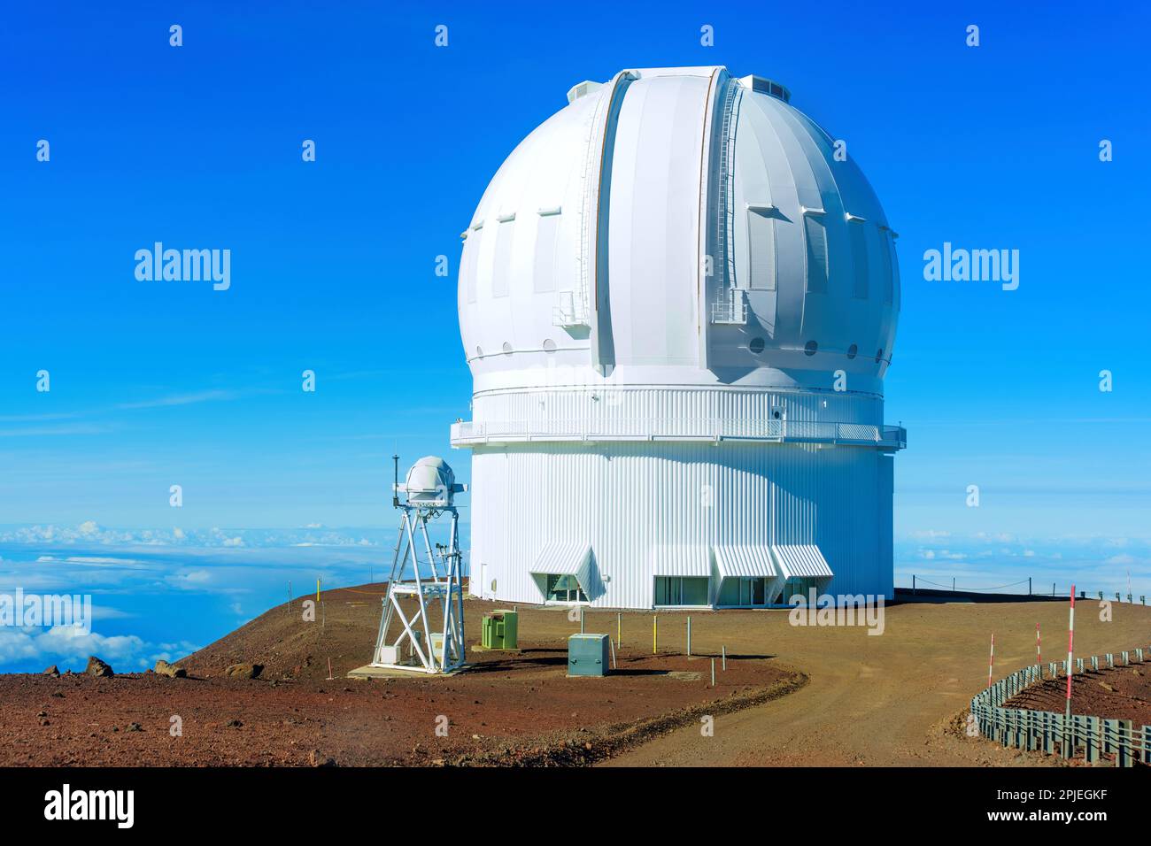 Observatory unit placed at the summit of Mauna Kea, set against a clear ...
