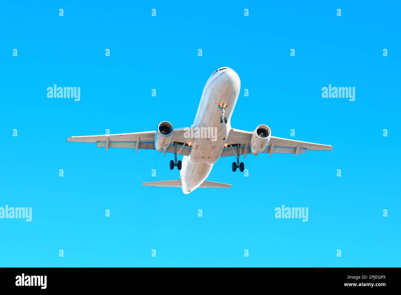 Plane soaring overhead, with a clear view of the underbelly and wings ...