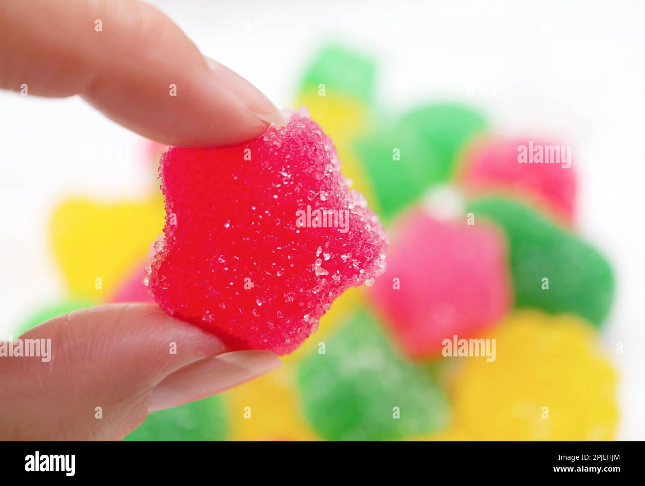 Woman Picking a Delectable Hot Pink Sugar Coated Soft Jelly Candy Stock ...