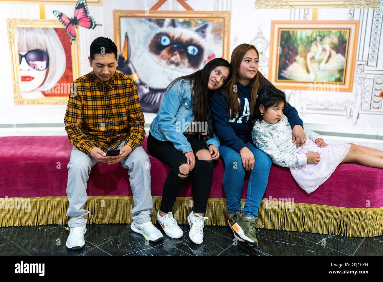 Ecuadorian migrant Klever Ortega, left, checks his phone as he visits ...