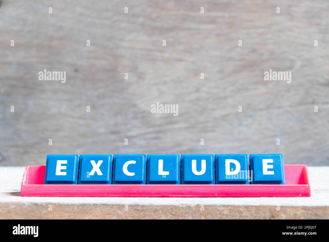 Tile alphabet letter with word exclude in red color rack on wood ...
