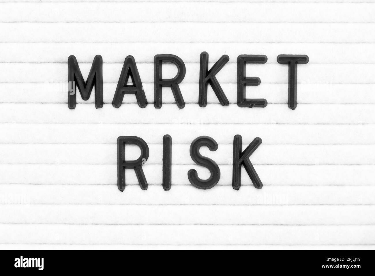 Black color letter in word market risk on white felt board background ...