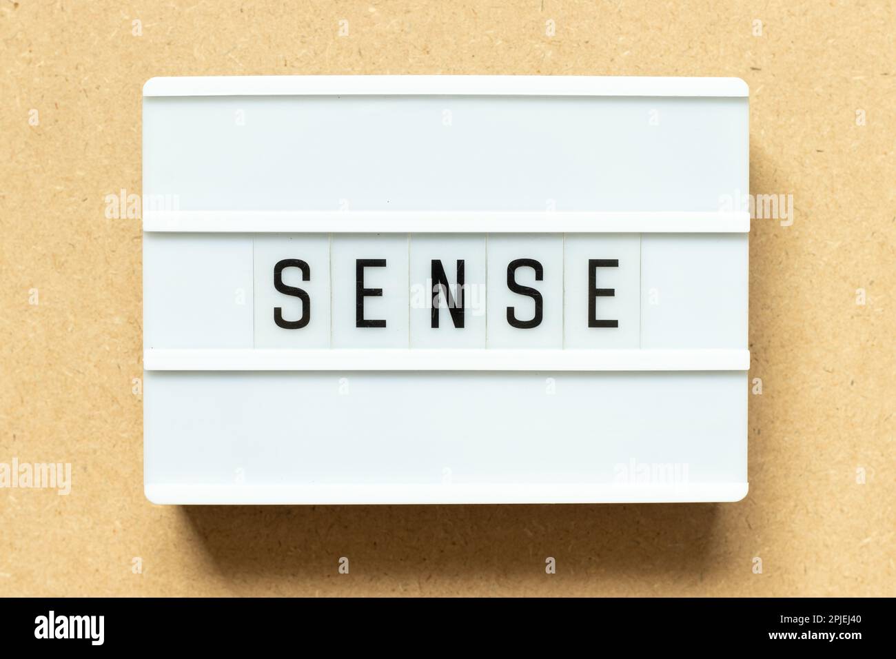 Lightbox with word sense on wood background Stock Photo - Alamy